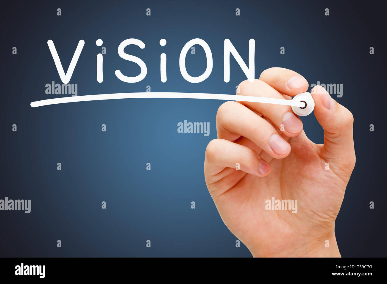 Hand writing the word Vision with white marker on transparent wipe ...