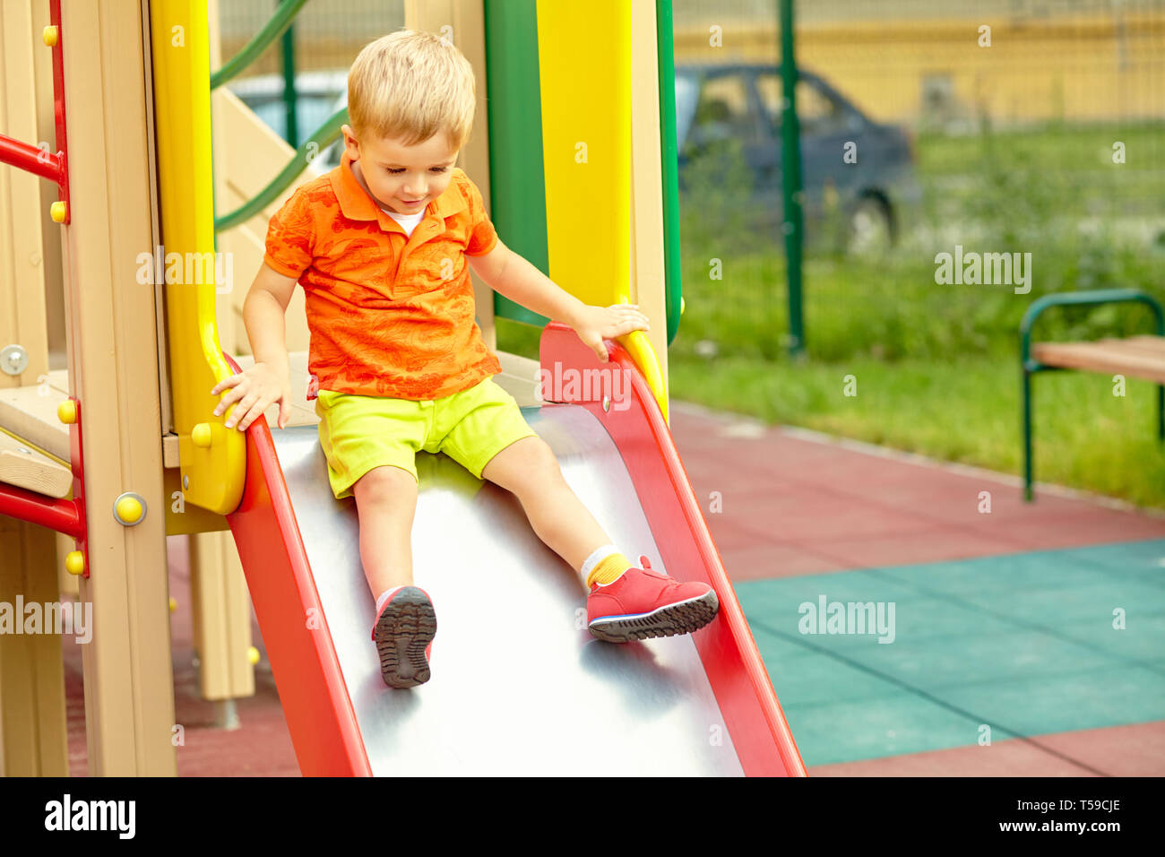 active little boy on playground. playing child on slide Stock Photo - Alamy