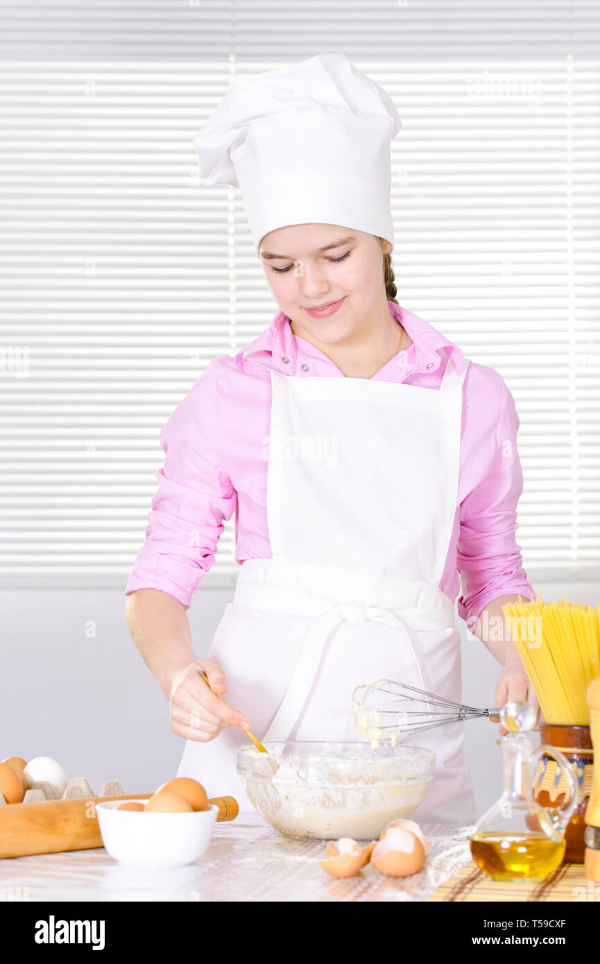 Cute girl cooking in the kitchen at home Stock Photo - Alamy