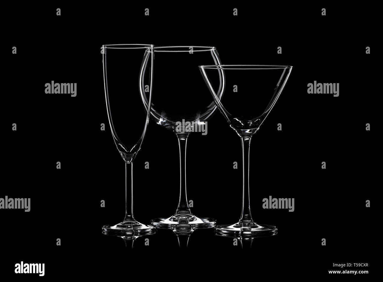 Empty cocktail glassware on a black background Stock Photo - Alamy