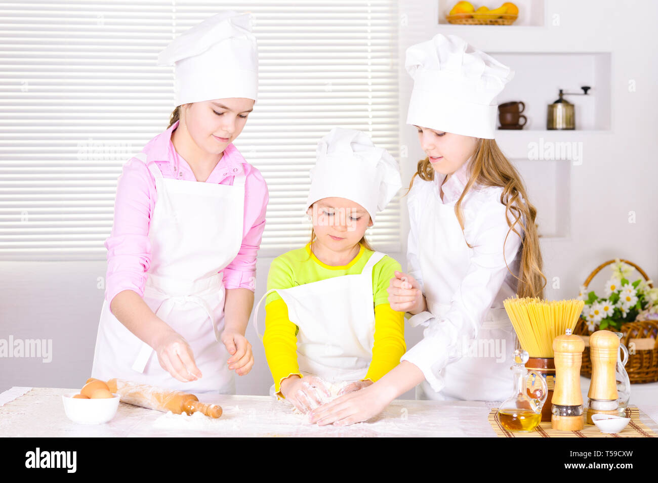 Portrait of cute girls cooking on kitchen Stock Photo - Alamy