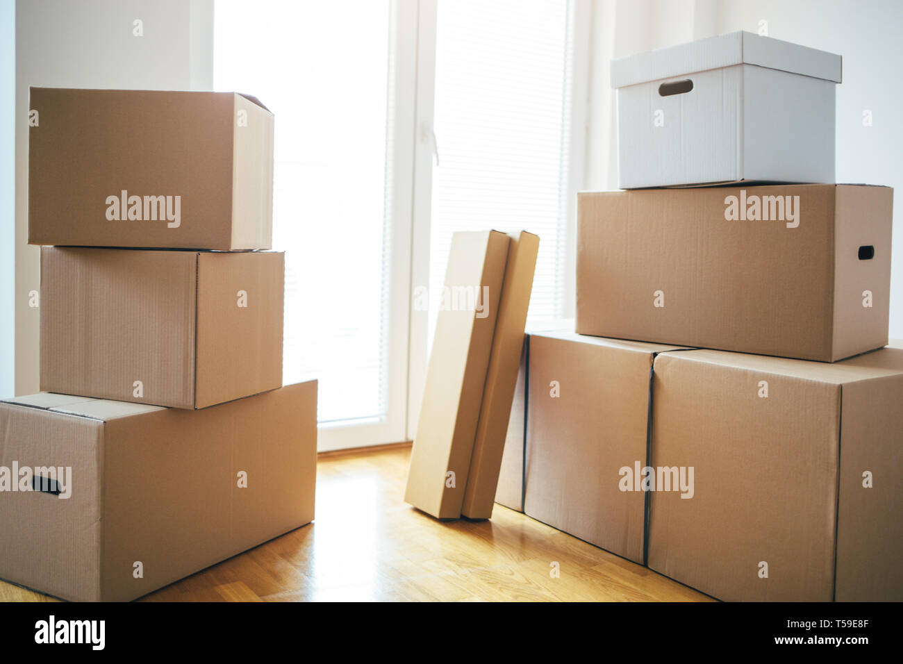 Moving boxes in new apartment. Moving into a new apartment Stock Photo ...