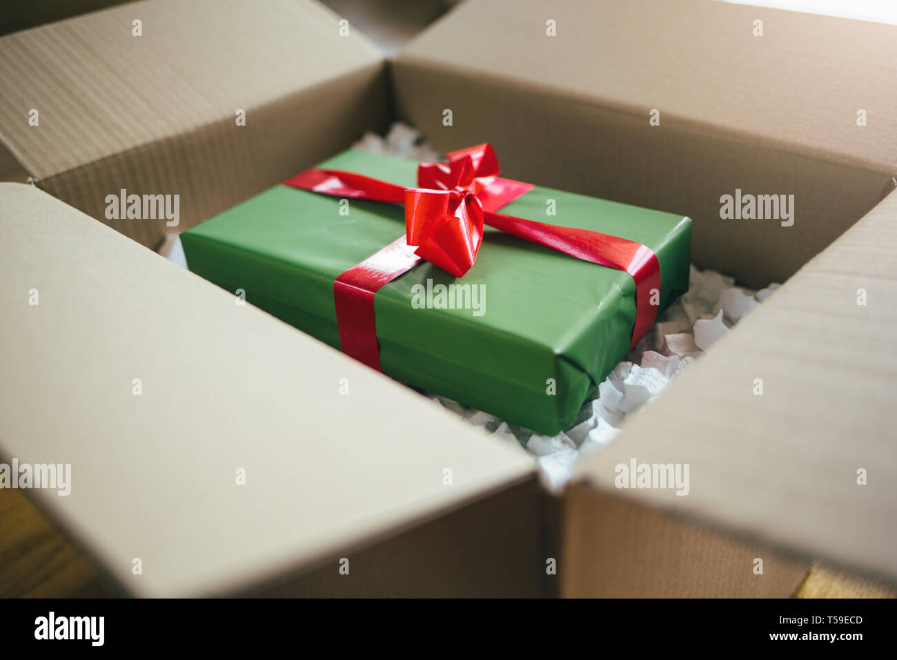 Parcel with gift box inside. Open parcel with present inside Stock ...