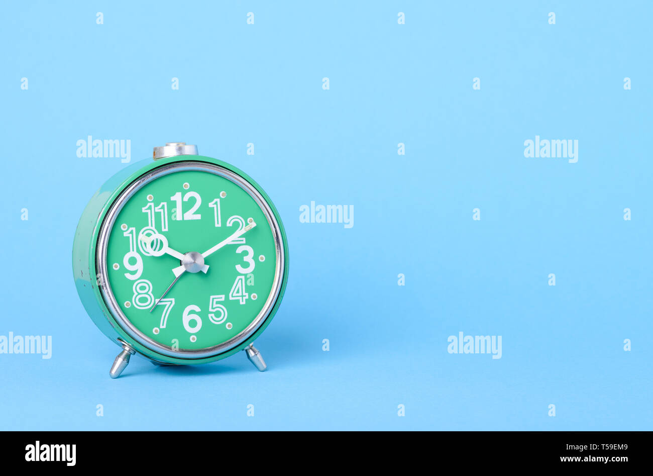 Old retro clock on blue background with copy-space Stock Photo - Alamy