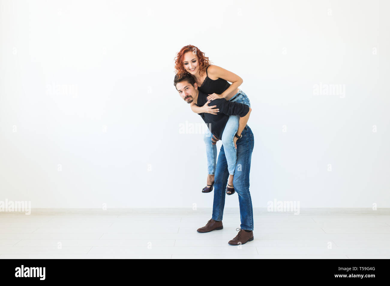 People and love concept - Beautiful pretty woman sitting at man's back ...