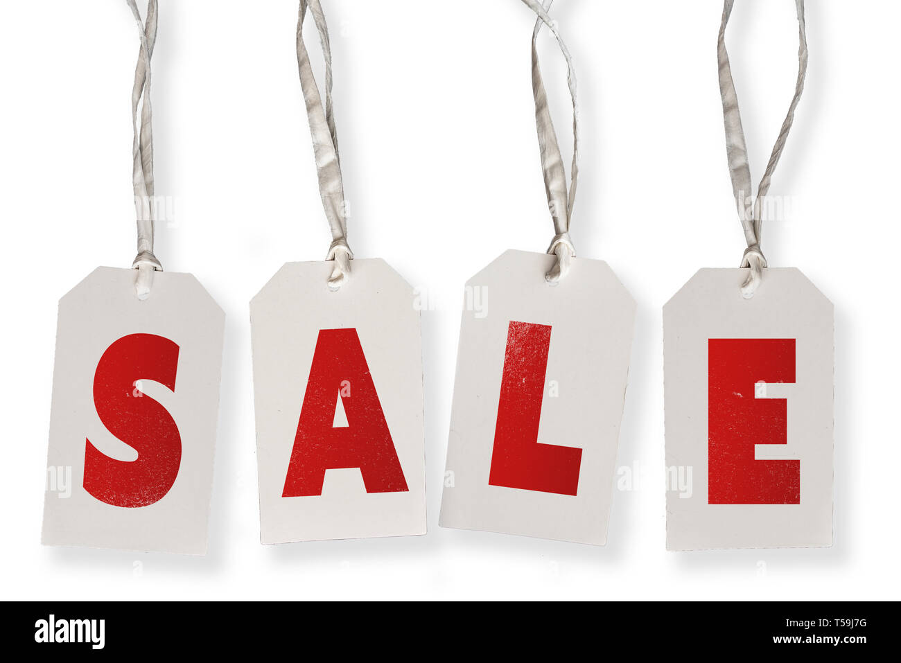 hanging cardboard tags with word SALE in red against white background ...