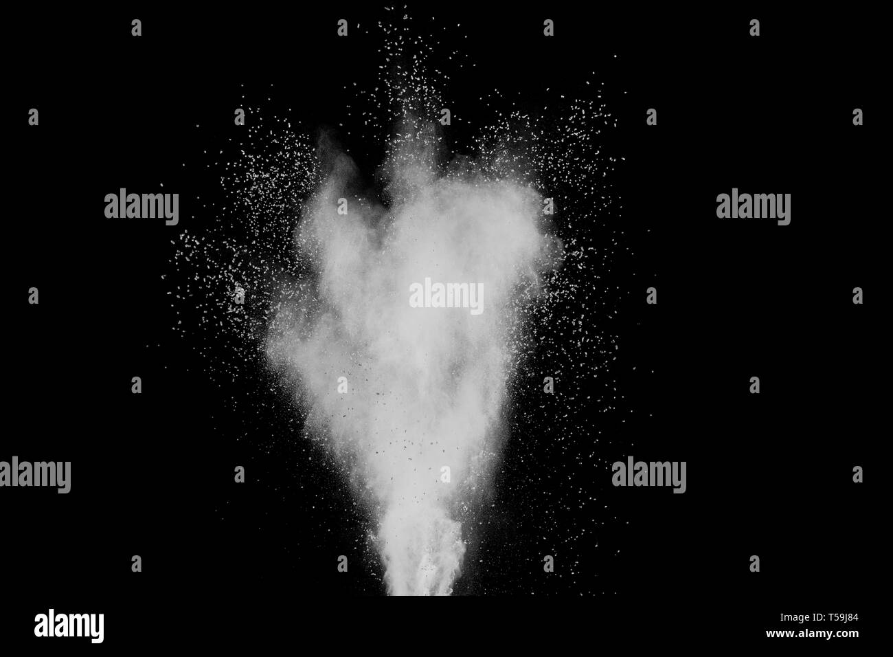White dust particles exhale in the air. Motion powder burst in dark ...