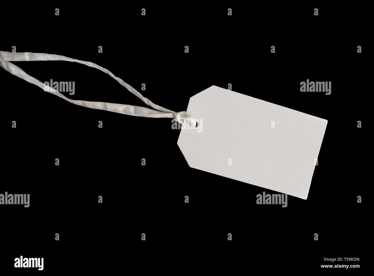 blank white hang tag cardboard lable with string attached on black ...
