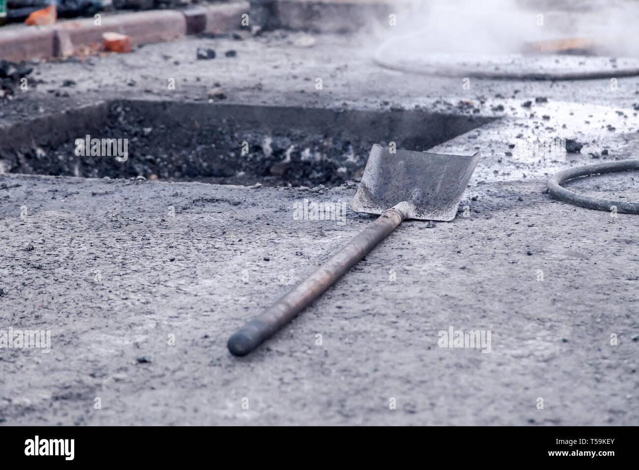 Closeup of professional tools for asphalt repair, road pit, shovel ...