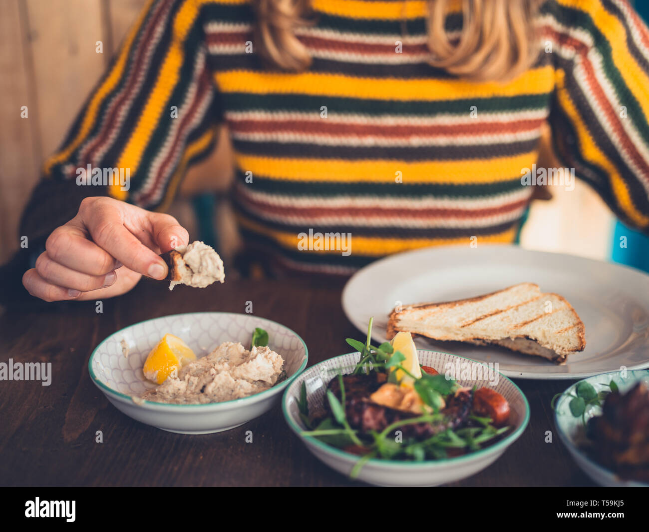 Woman eating in a restaurant hi-res stock photography and images - Alamy
