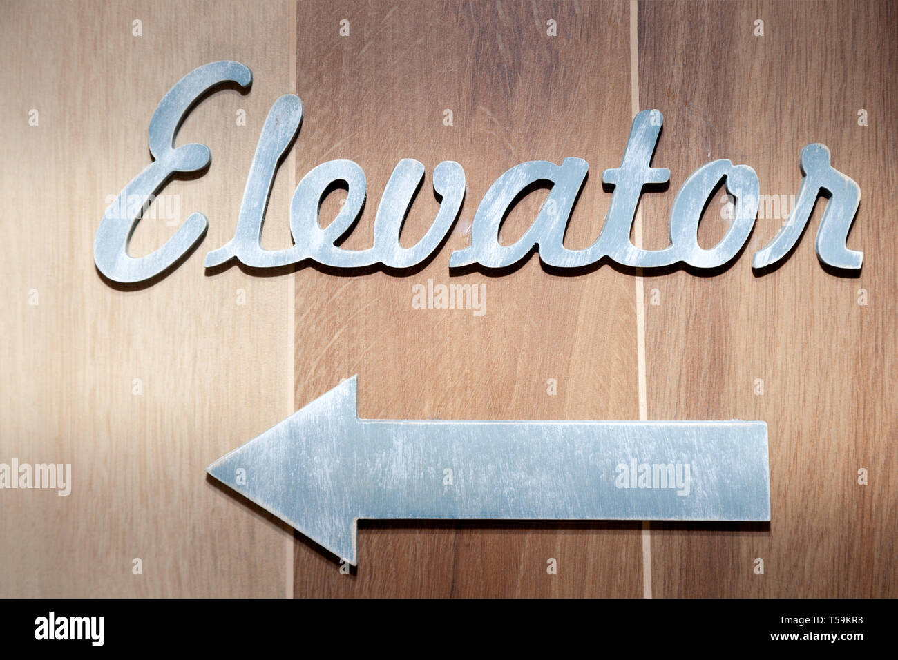 Silver metal letters, pointer of elevator, lift sign on the wall hotel ...