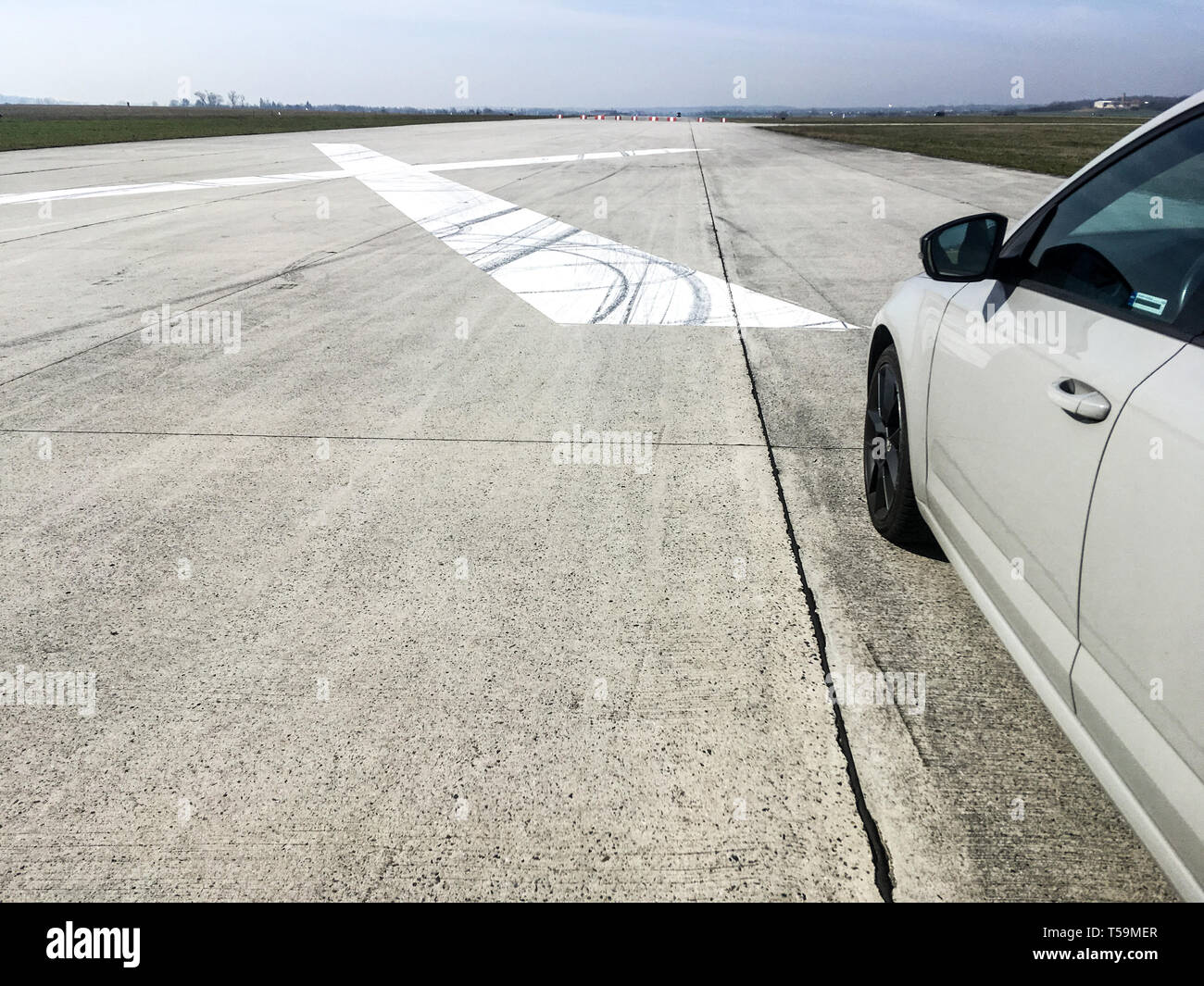A picture of a car standing on the airport runway before test of ...