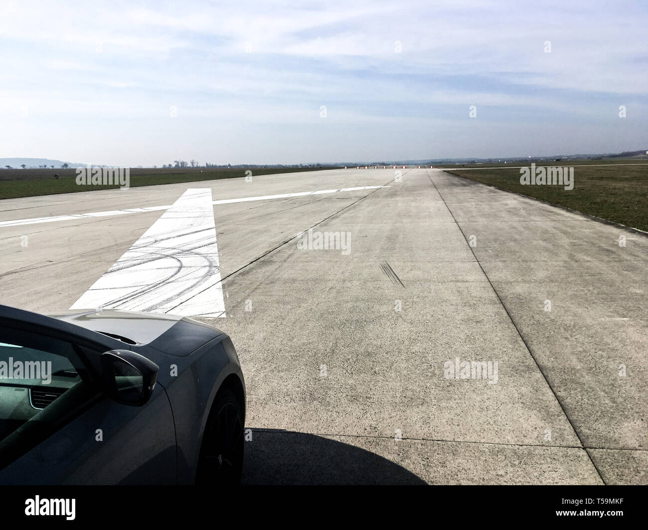 A picture of a car standing on the airport runway before test of ...