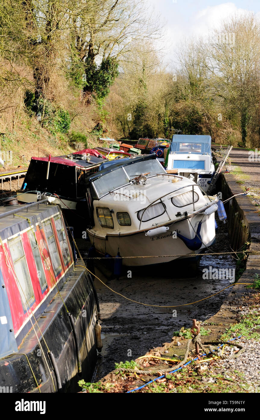 Boats grounded in an empty canal that has been drained for maintenance ...