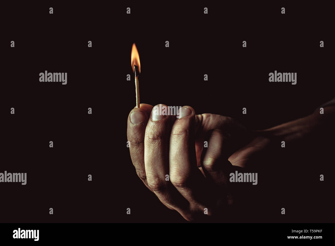 Burning match in the man's hand. Dangerous game with fire Stock Photo ...