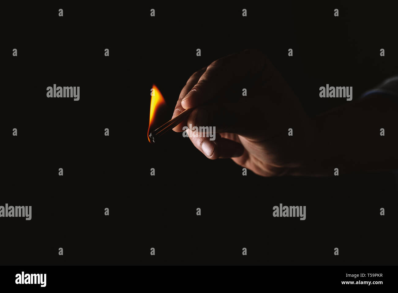 Burning match in the man's hand. Dangerous game with fire Stock Photo ...