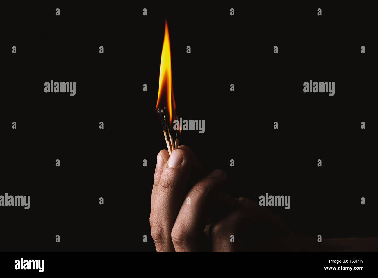 Hand holding burning match hi-res stock photography and images - Alamy