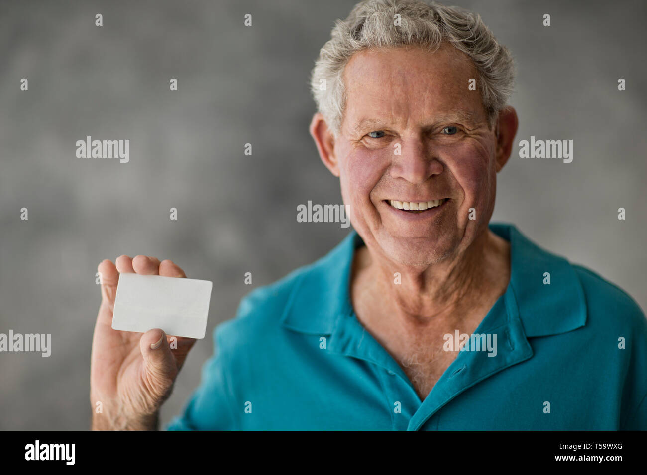 Portrait of a smiling elderly man holding a blank card Stock Photo - Alamy