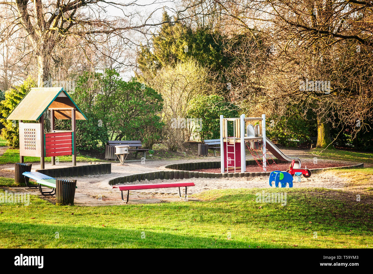 Playground in public city park. Early spring landscape and urban ...