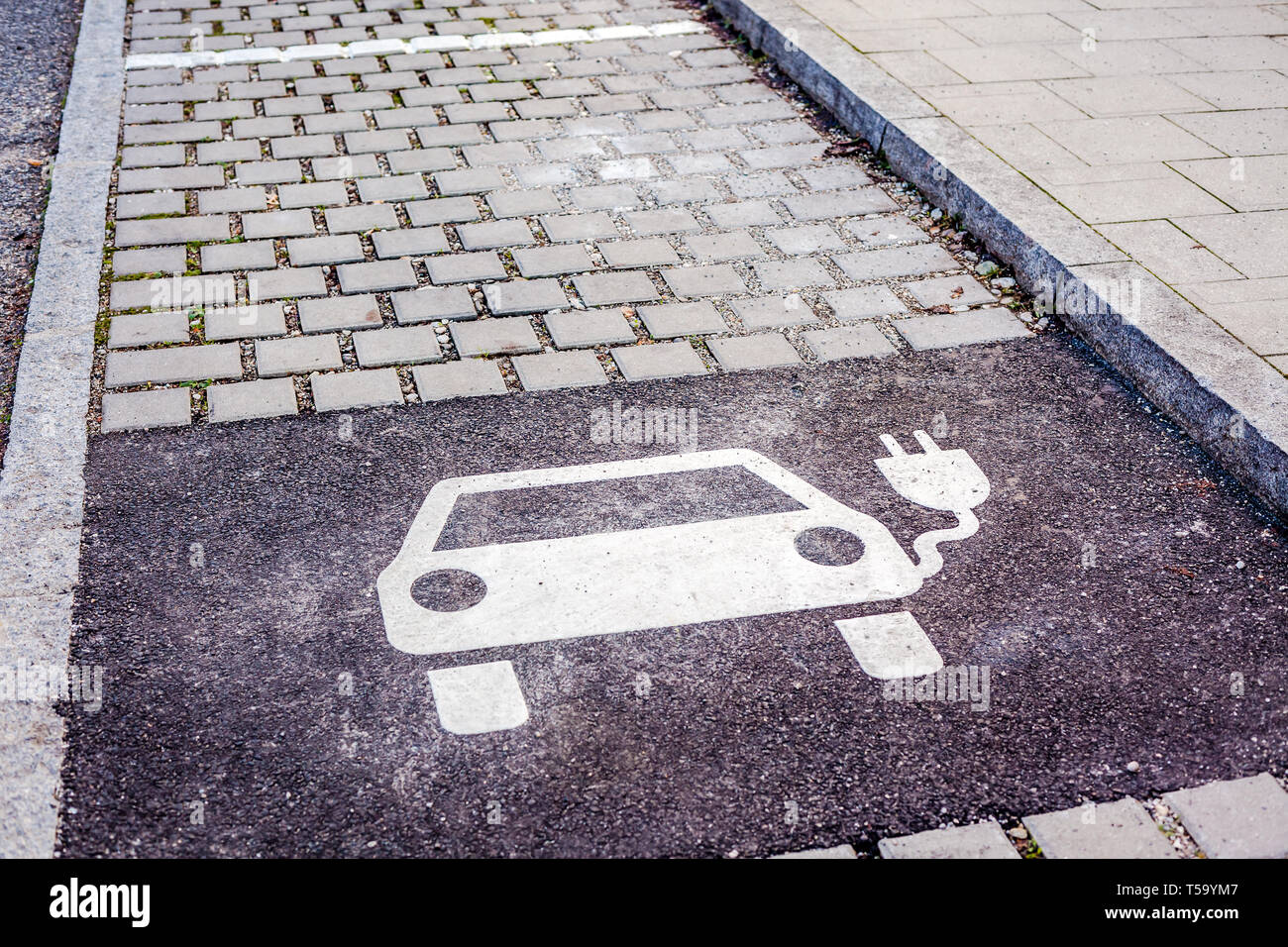 Electric vehicle charging station sign on asphalt parking lot. Eco ...