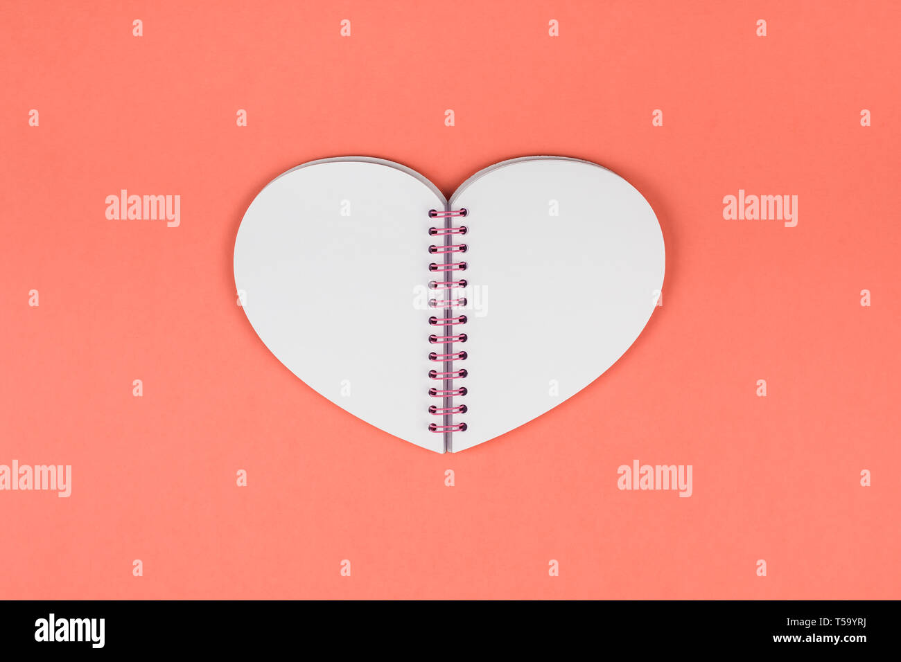 Creative top view flat lay of heart shaped notepad with blank pages as ...