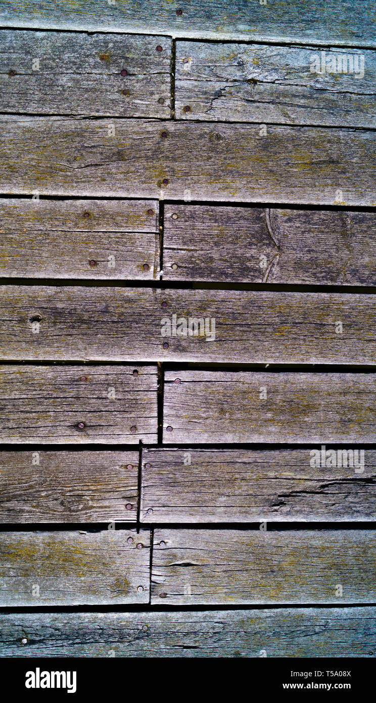 Top down view of old wooden pier planks forming wooden textured pattern ...