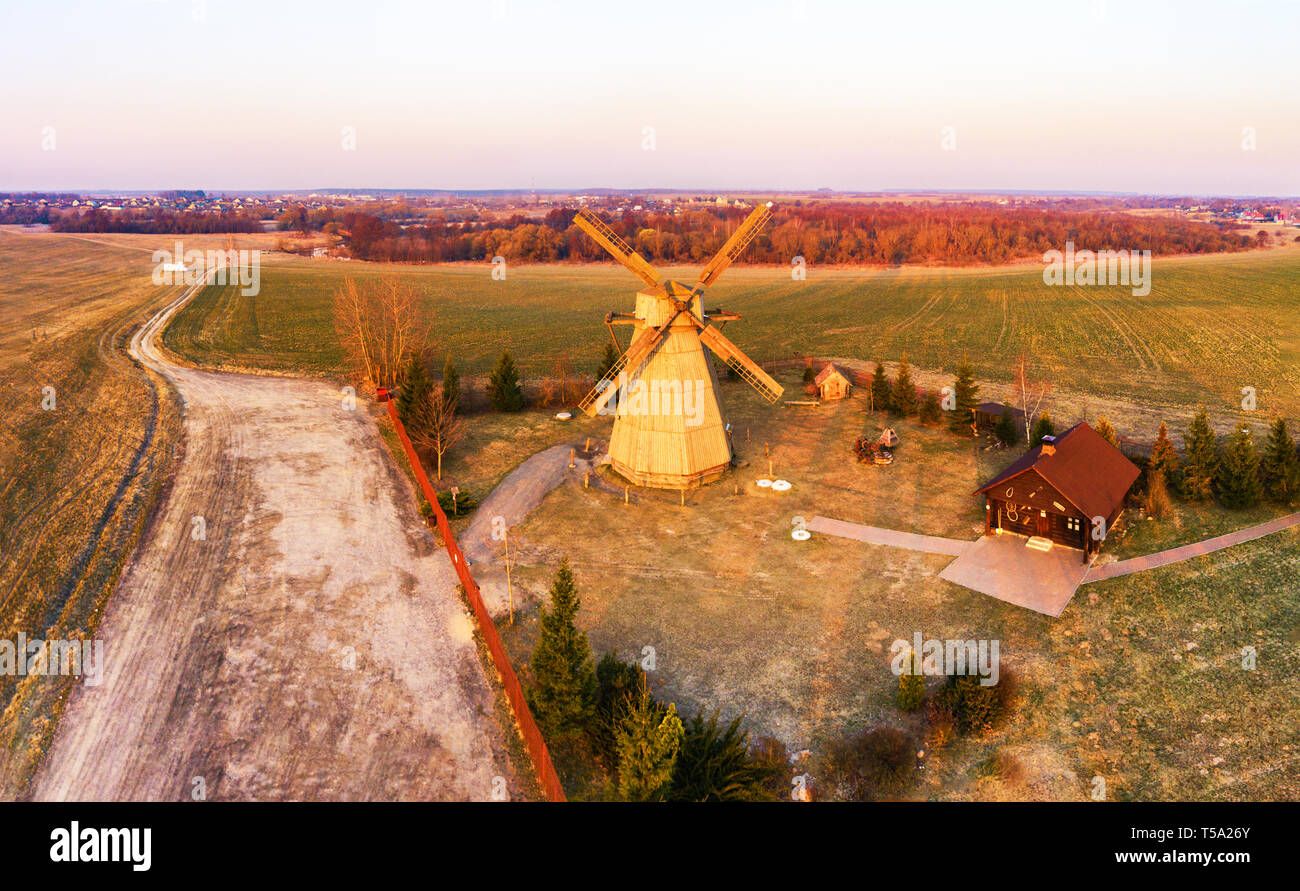 Sunrise at the spring fields. Traditional windmill in morning light ...