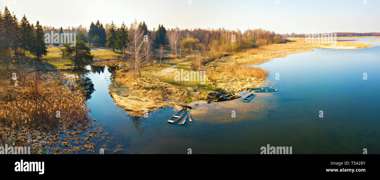 Spring aerial landscape. Panorama of lake in forest at morning time ...