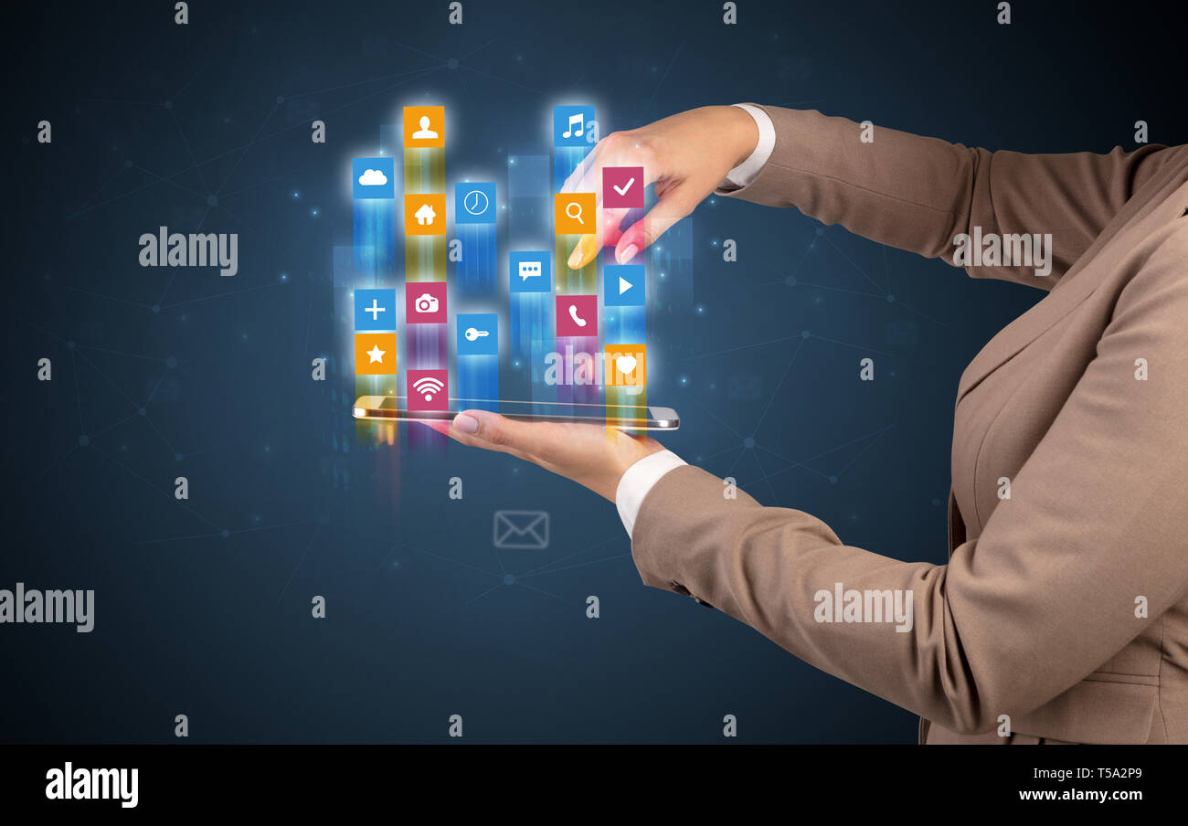 Female elegant hand holding tablet with colourful application icons ...