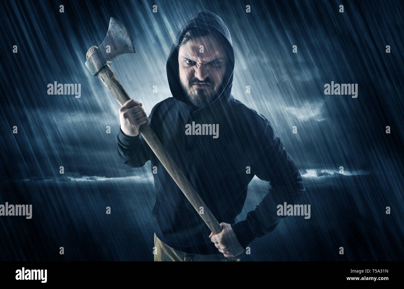 Masked armed poacher in mysterious rainy coastal weather concept Stock ...