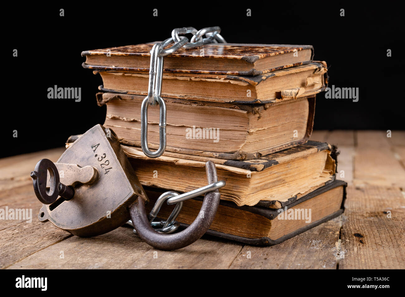 Old books bound by a new shiny chain with an old padlock. Forbidden old ...