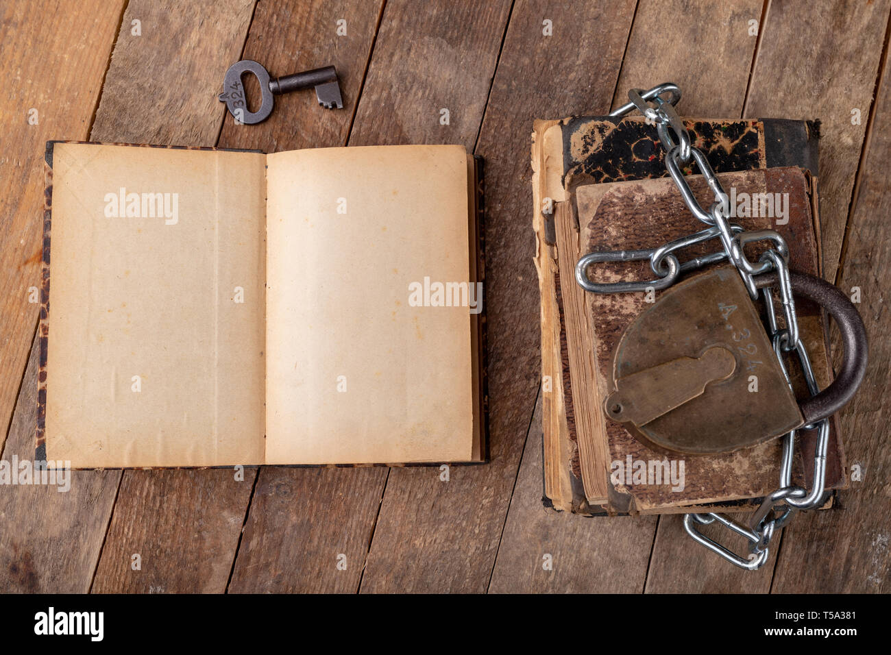 Old books bound by a new shiny chain with an old padlock. Forbidden old ...