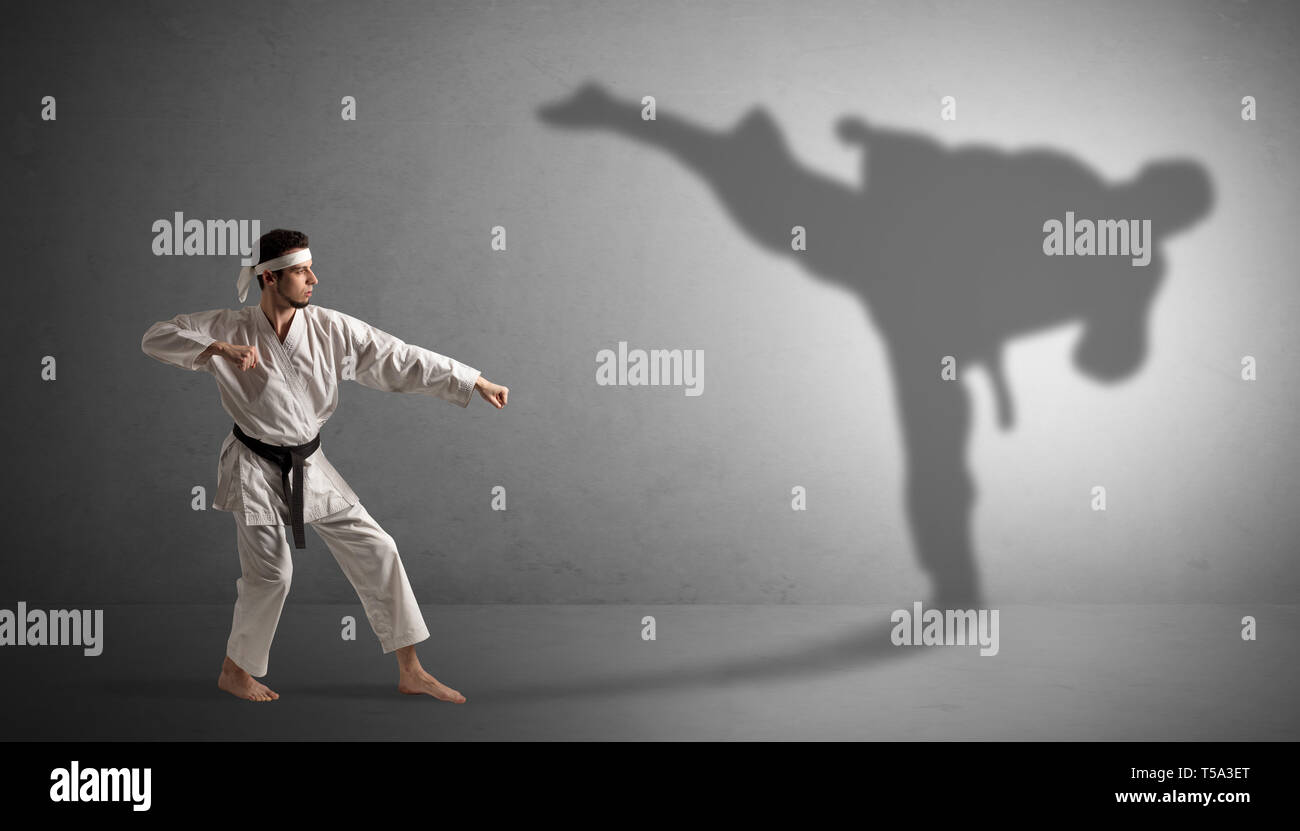 Young karate man confronting with his own shadow Stock Photo - Alamy