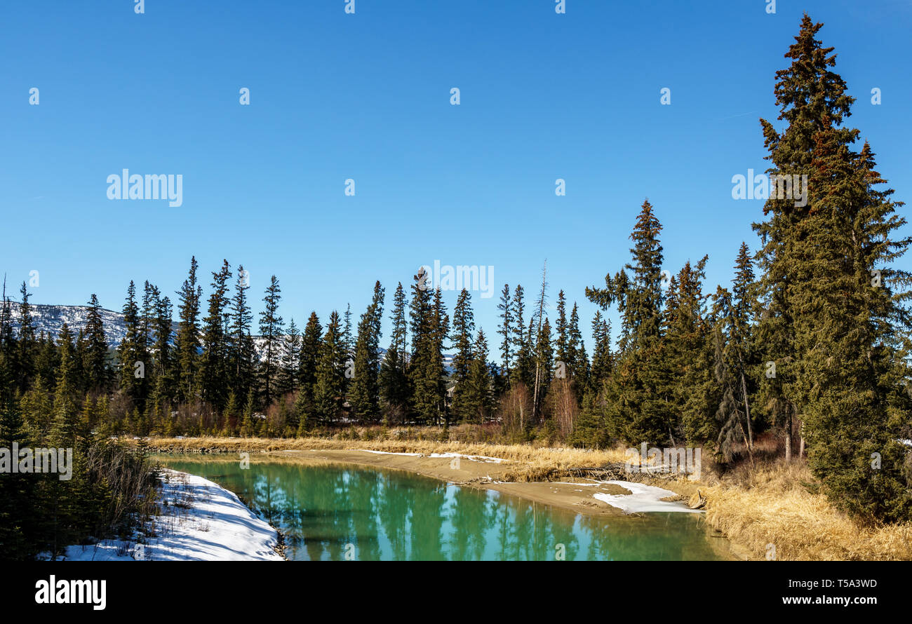 mountain river with wooden bridge in early spring eastern british ...