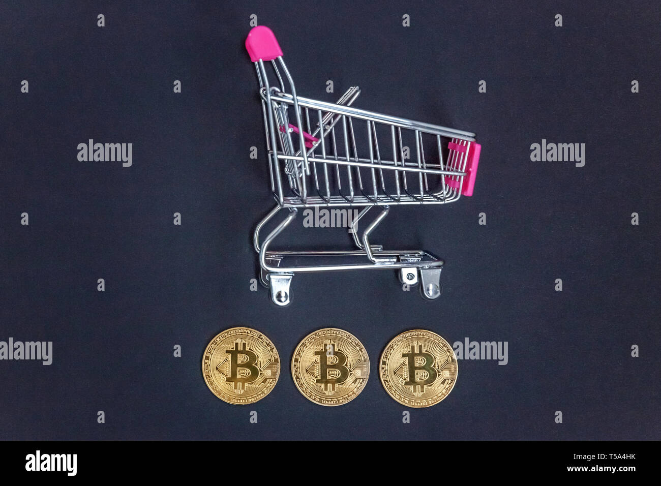 Stack of coins bitcoin in mini shopping cart toy, concept of mining ...