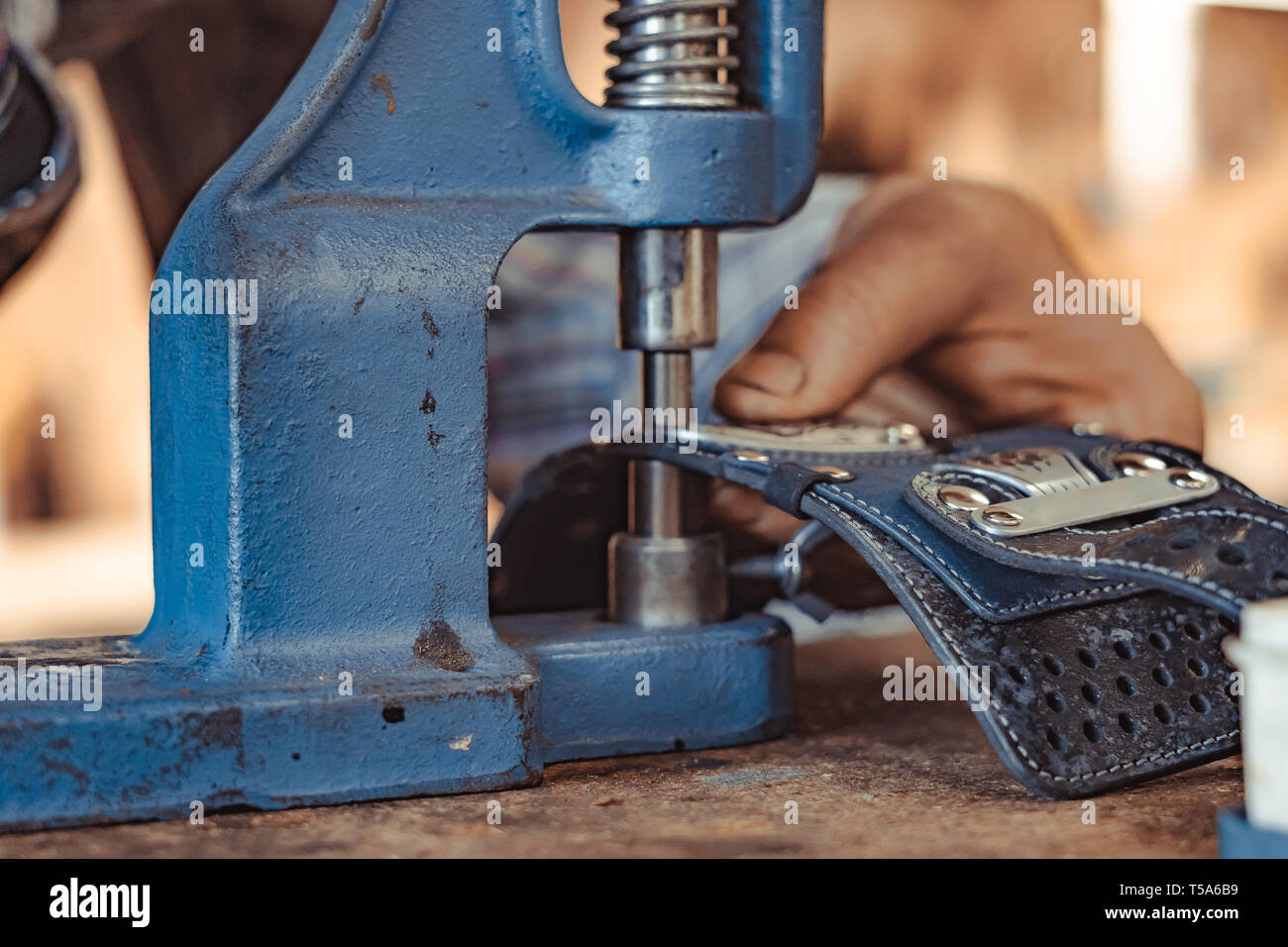 Man works in carpentry workshop. He fixes wooden handle in vice ...