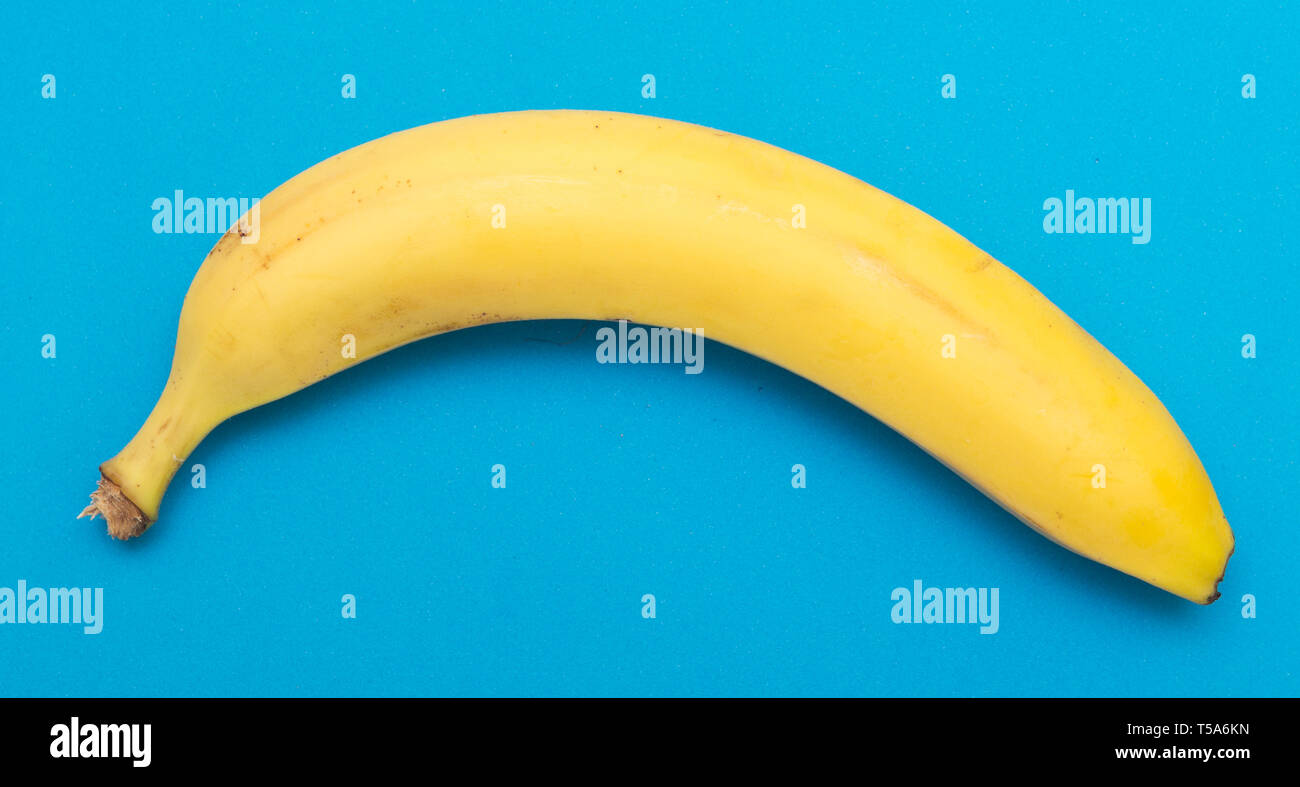 Banana on blue background Stock Photo - Alamy