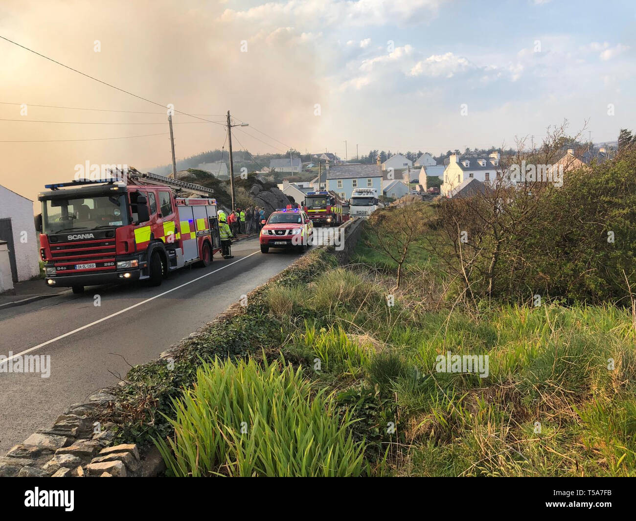 Firefighters work to control a gorse fire that put a number of homes at ...