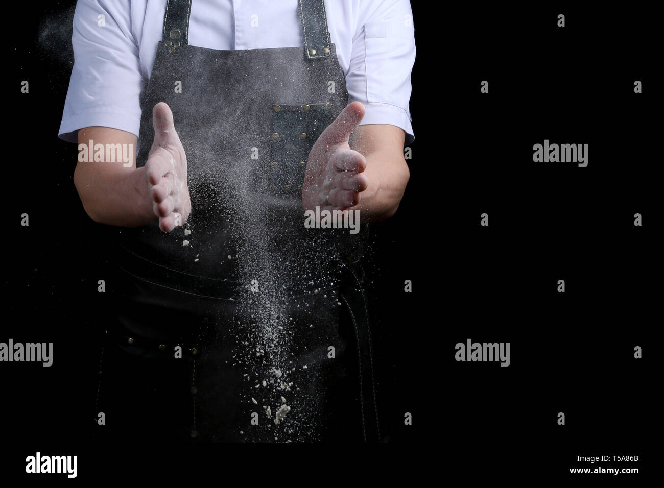 hands and flour in splash baker clap on black background Stock Photo ...