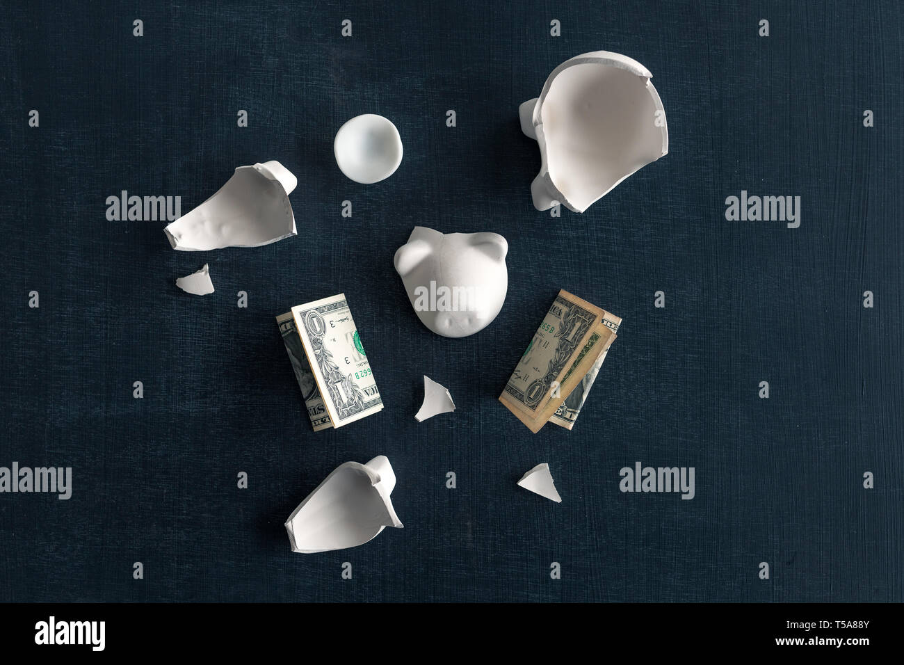 Dollars in broken piggy coin bank, money savings in home budget and ...