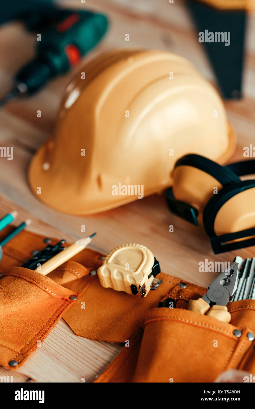 Carpentry tools and protective equipment on the desk in woodwork ...
