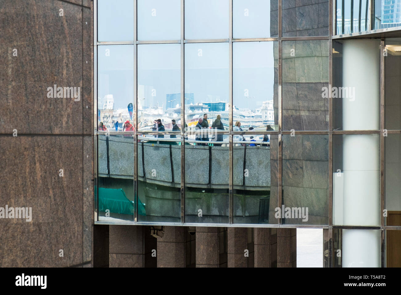 Distorted reflections of people and buildings seen in a window Stock ...