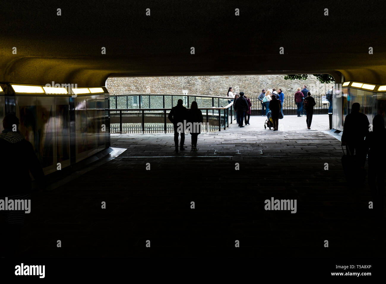 People walking through a large dark underpass in London Stock Photo - Alamy