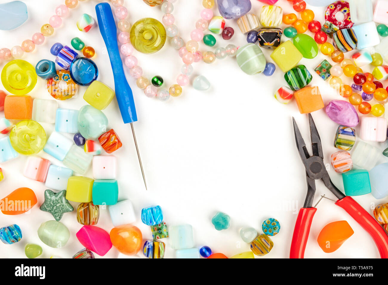 An overhead photo of many different beads with tools for making ...
