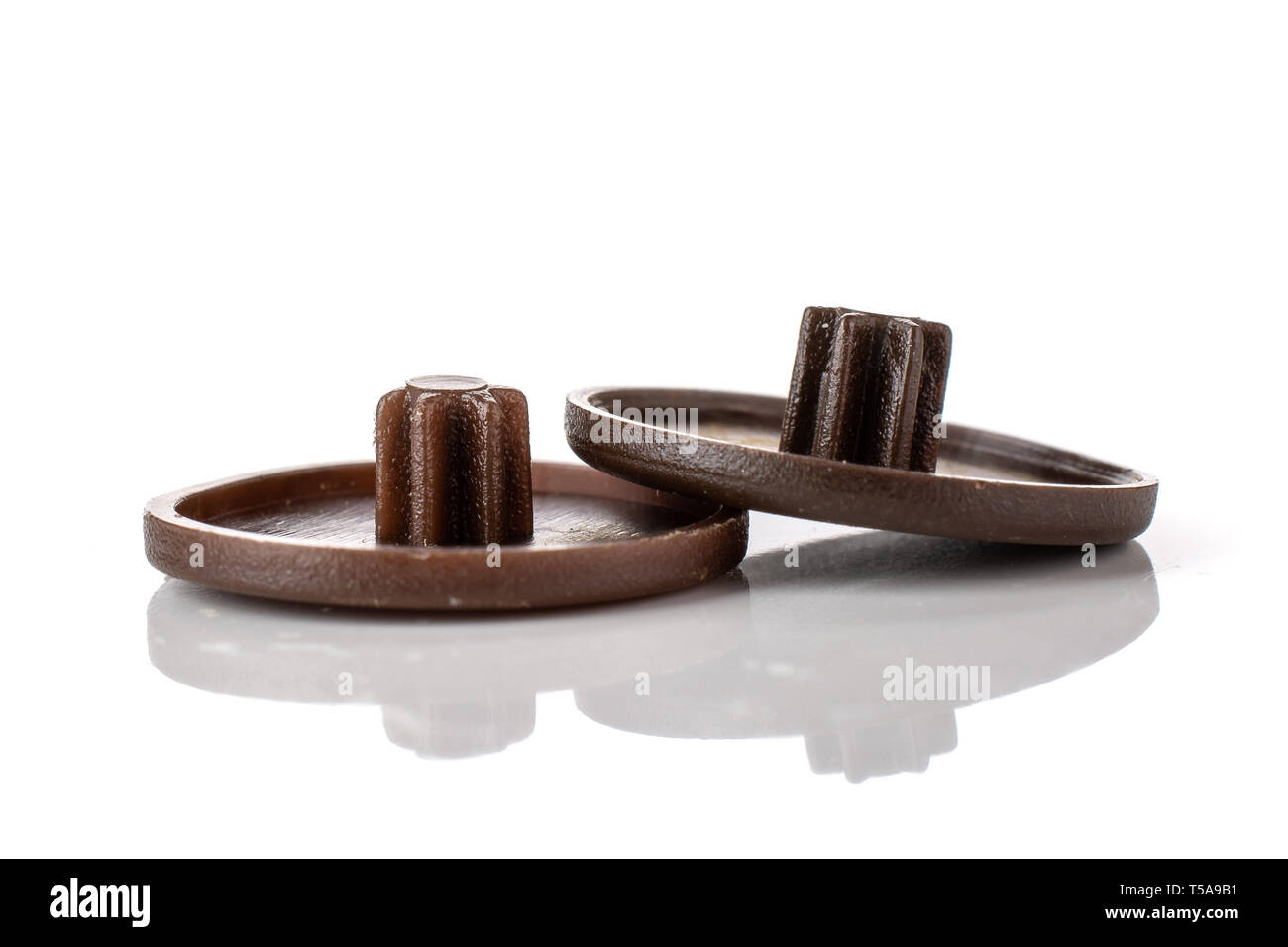 Group of two whole dark brown plast plugs work item isolated on white ...