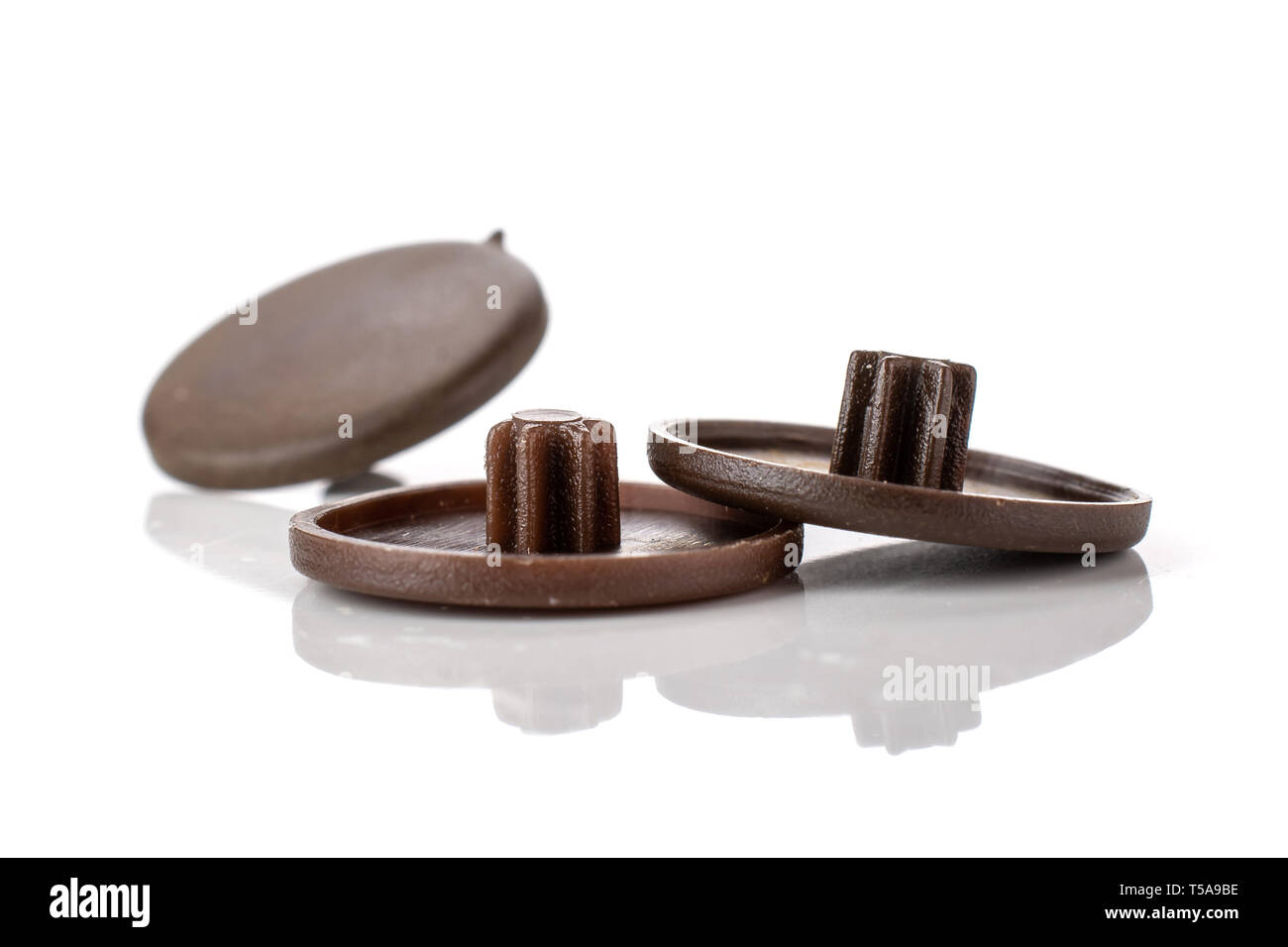 Group of three whole dark brown plast plugs work item isolated on white ...