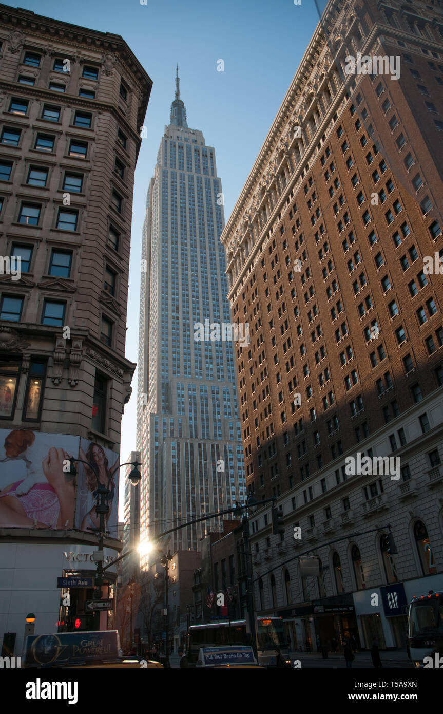 Empire State Building peaking out between two buildings, New York City ...