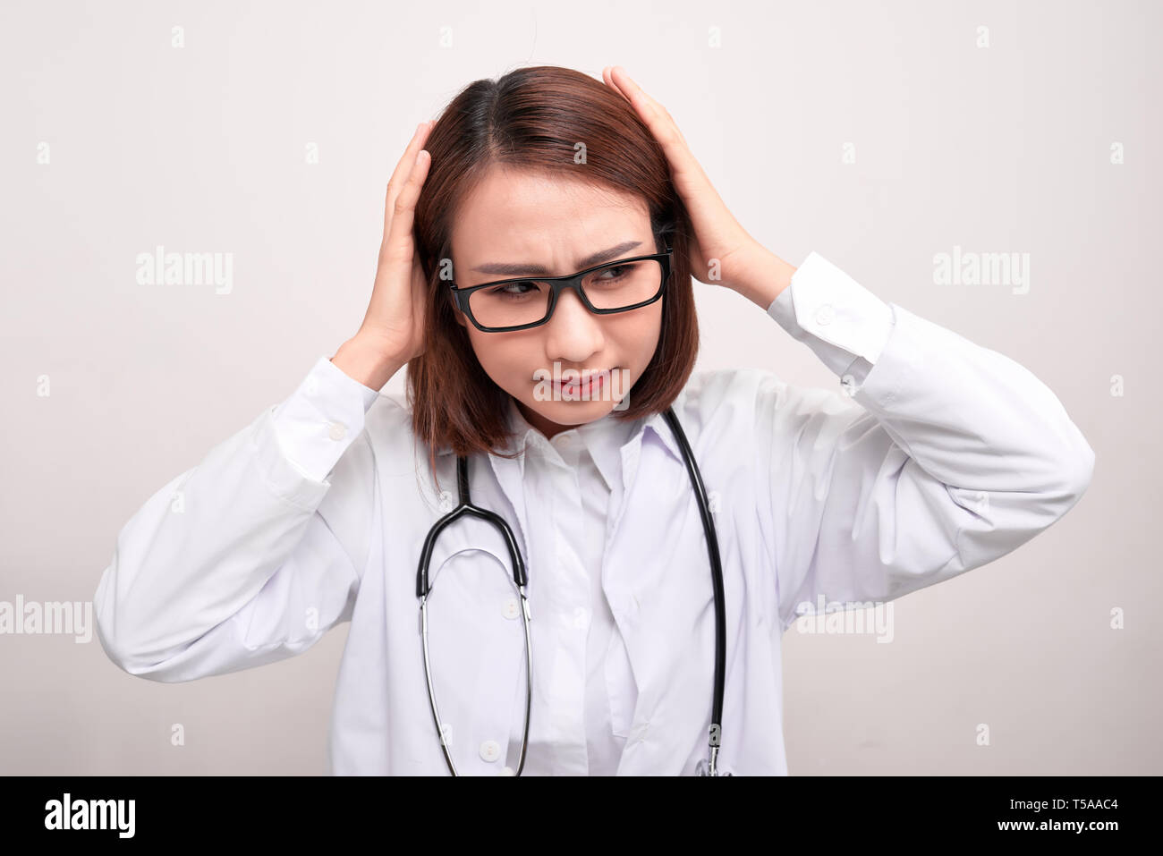 medical doctor woman with stethoscope problem, hold hand head on white ...