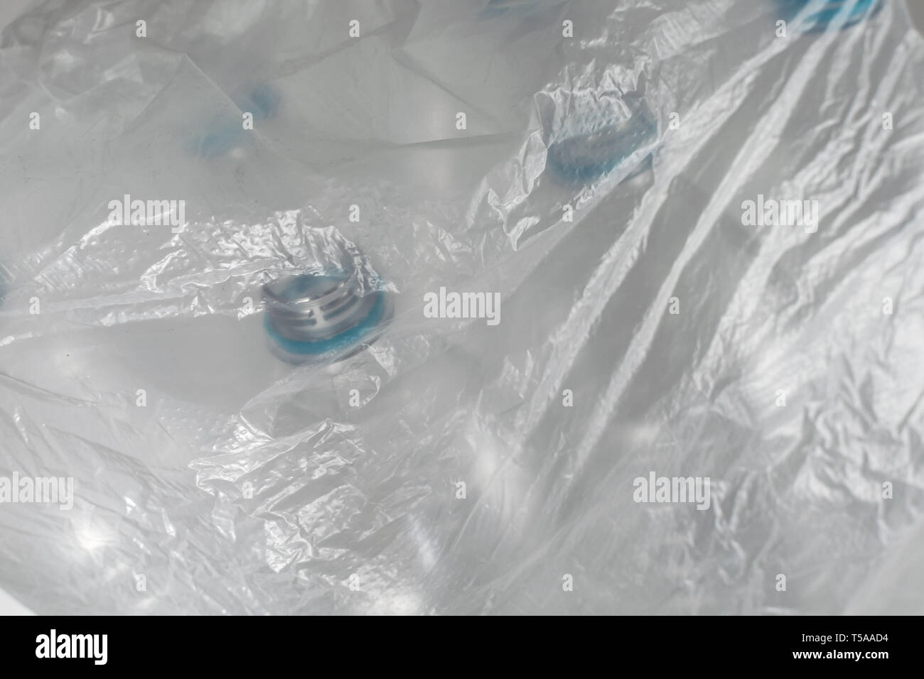 Transparent plastic bag with several empty plastic bottles inside on a ...