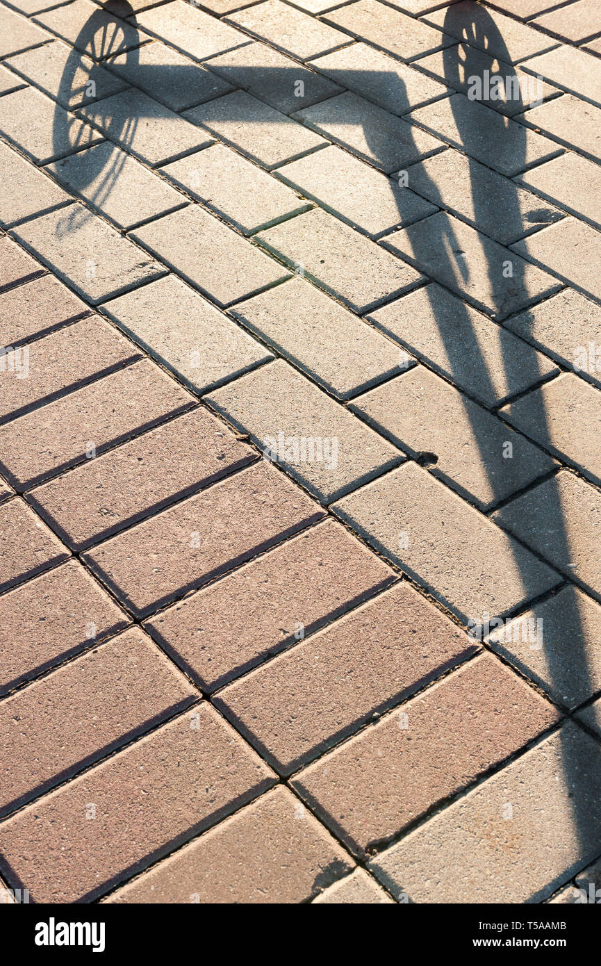 shadow scooter on the stone walkway Stock Photo - Alamy